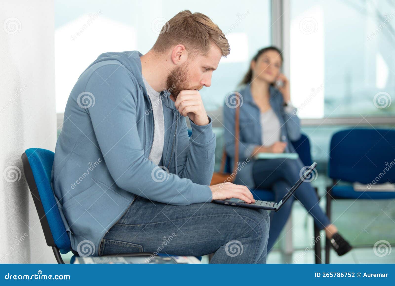 Young Man in Waiting Room Using Computer Stock Photo - Image of time ...