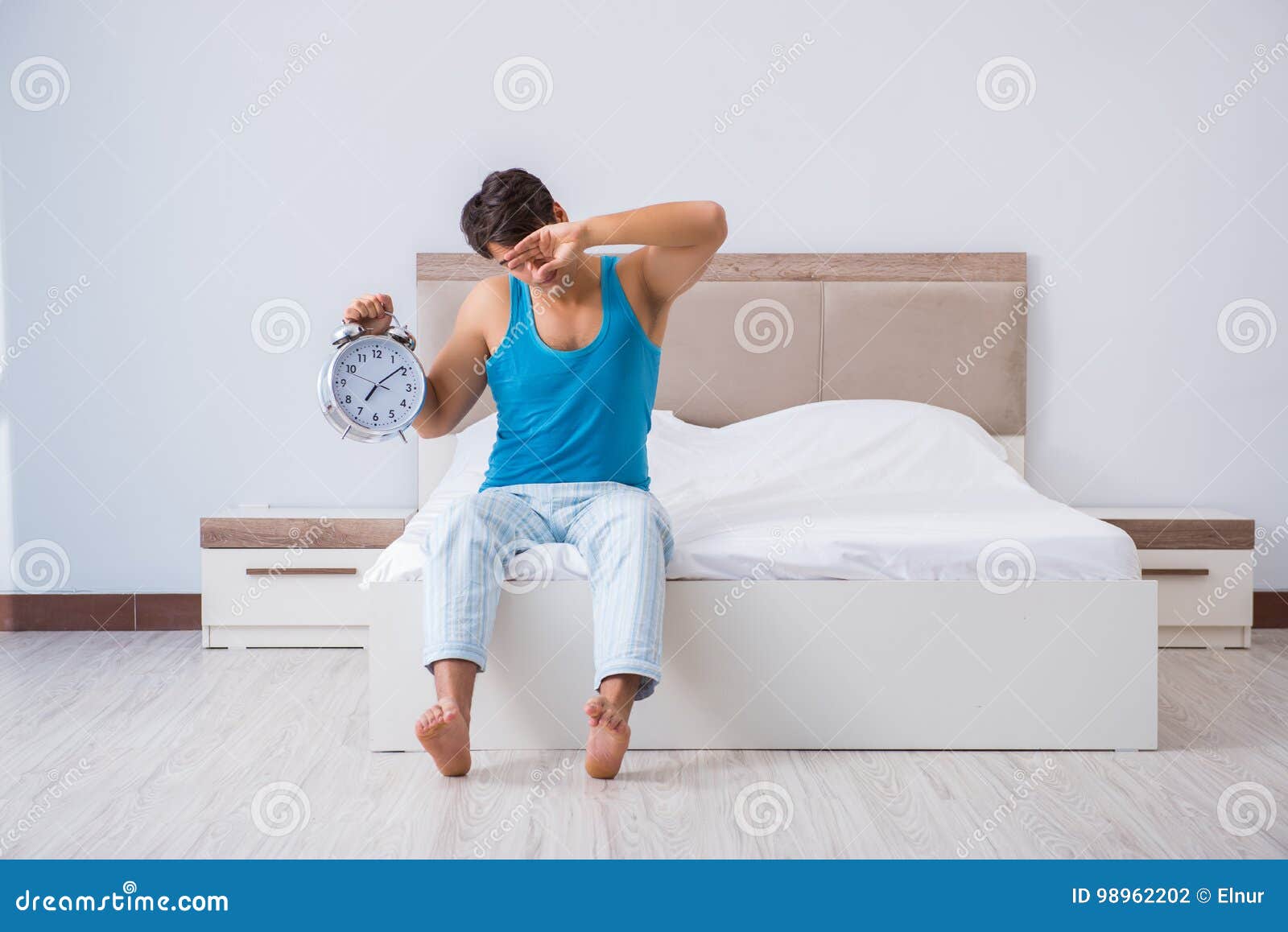 The Young Man Waking Up in Bed Stock Photo - Image of bedroom, pyjamas ...