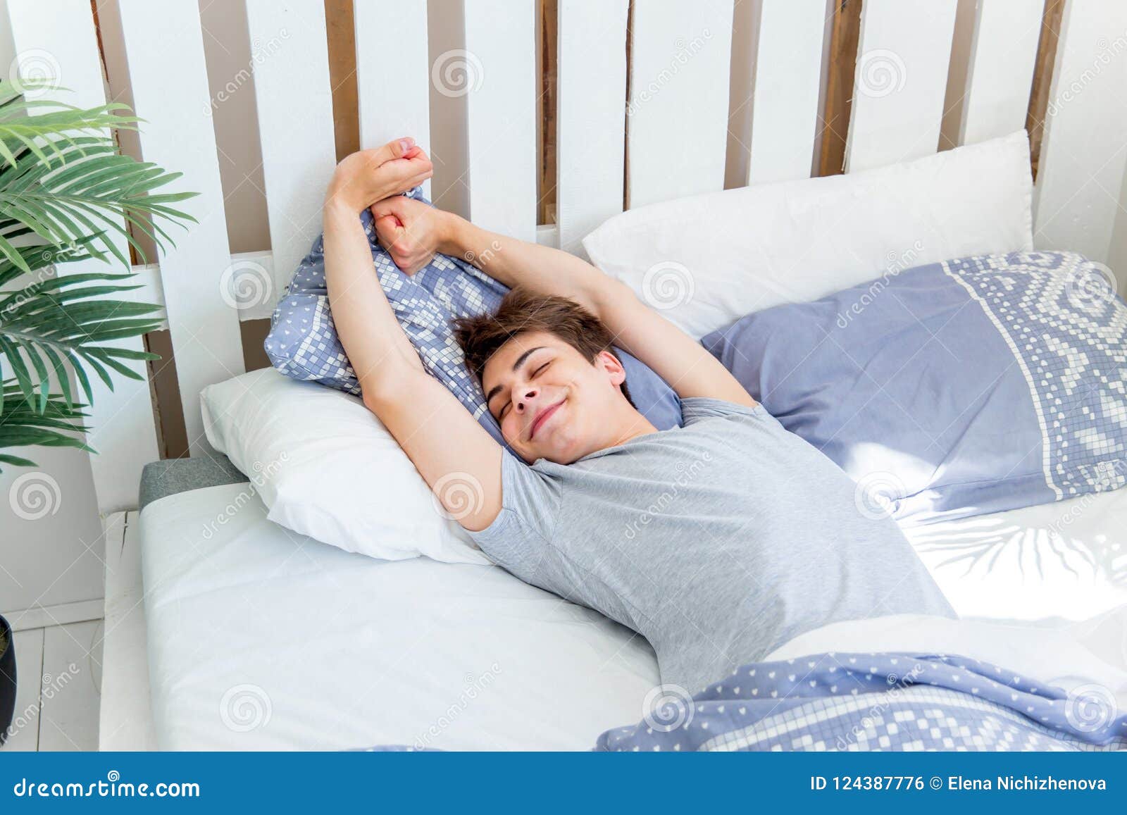 A Young Man Waking Up in Bed in the Morning Stock Photo - Image of ... A Young Man Waking Up in Bed in the Morning Stock Photo - Image of ...