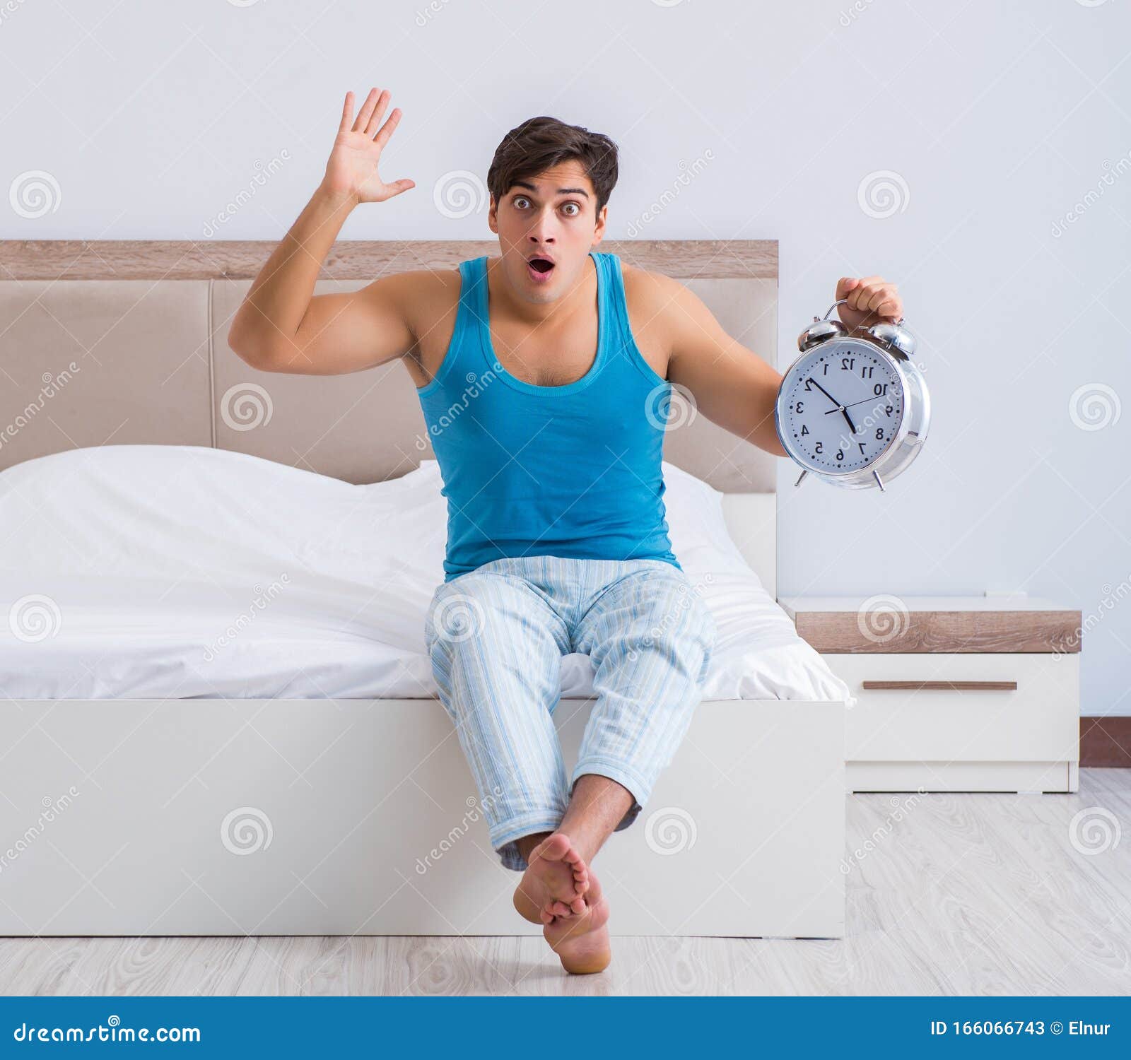 Young man waking up in bed stock image. Image of shocked - 166066743