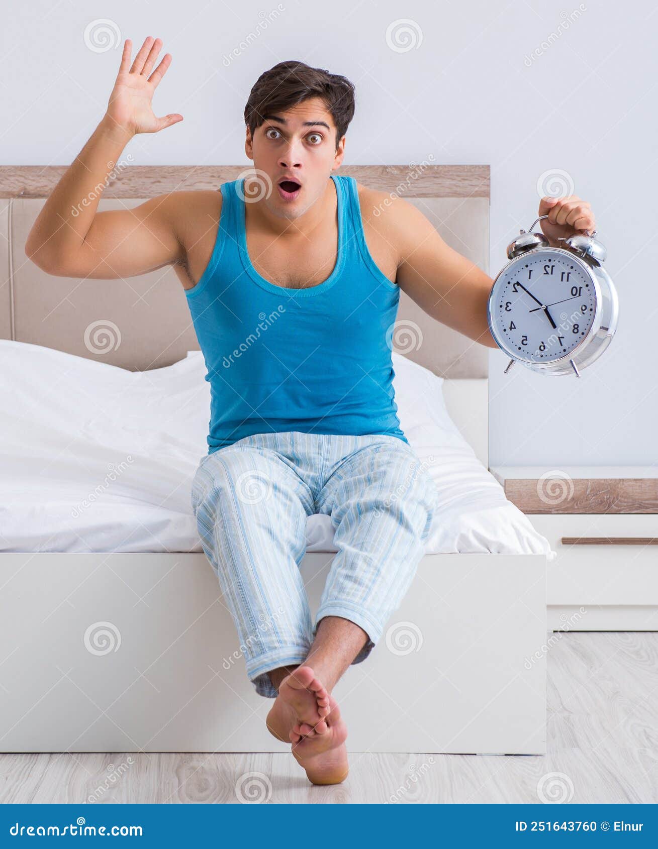 Young man waking up in bed stock photo. Image of morning - 251643760