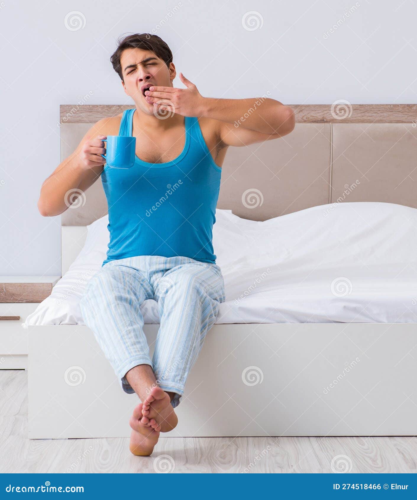 Young man waking up in bed stock photo. Image of resting - 274518466