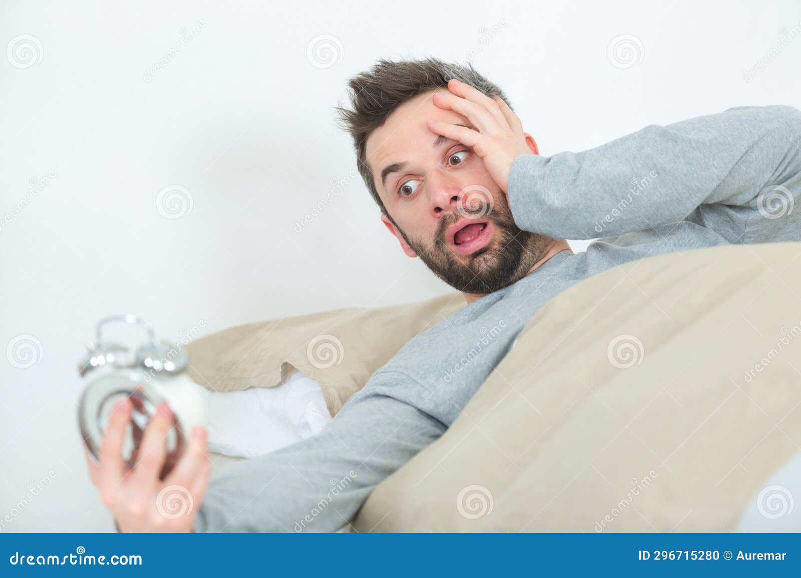 Young man waking up late stock photo. Image of resting - 296715280