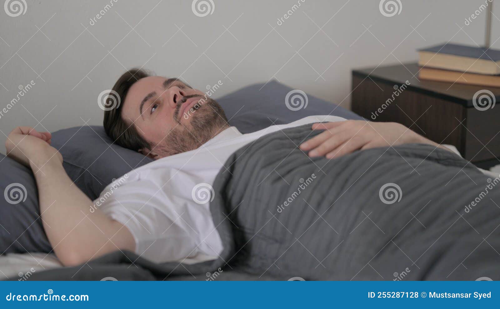 Young Man Waking Up from Nightmare in Bed Stock Photo - Image of busy ...