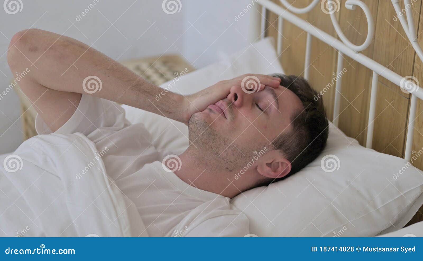 Young Man Waking Up from Sleep in Bed Stock Photo - Image of sleeping ...