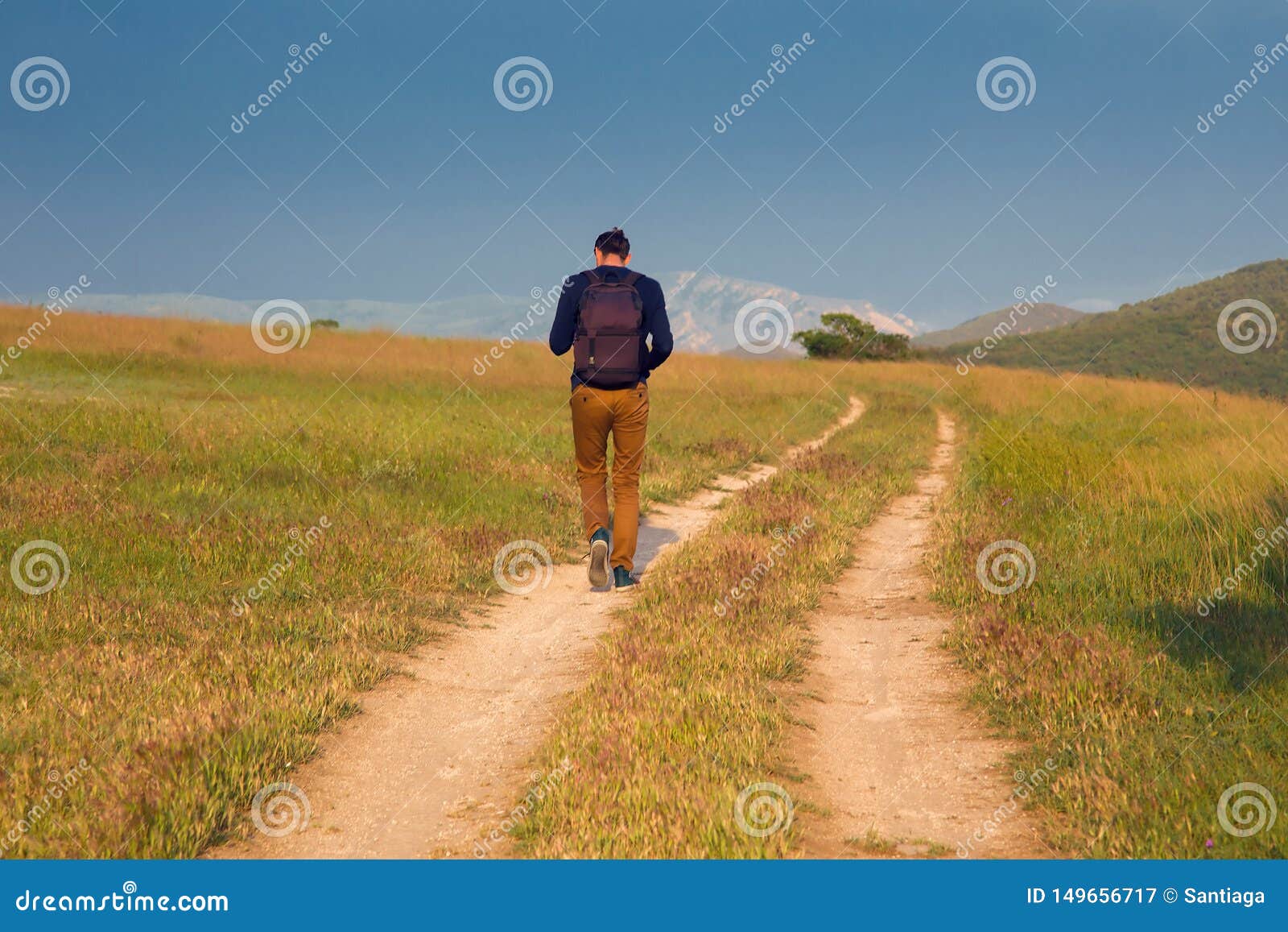 Young Man Walking on a Countryside Road Stock Image - Image of distance ...