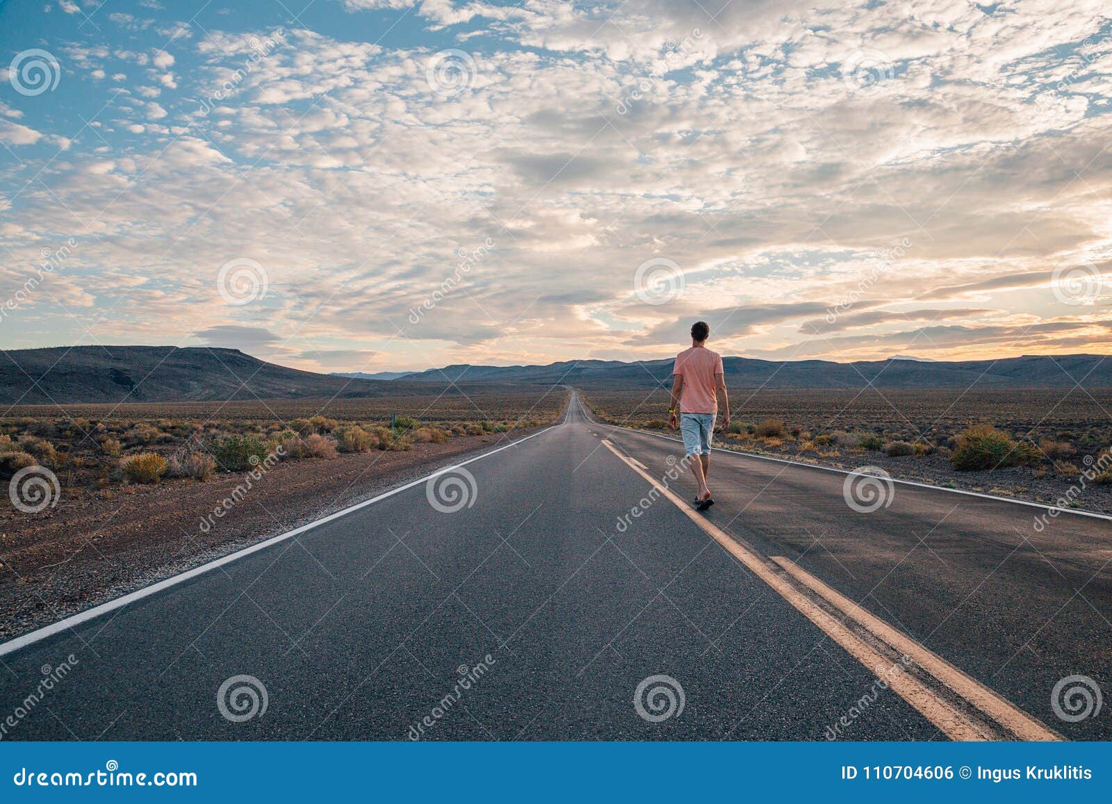 Young Man Walking Down the Endless Road Stock Photo - Image of dunes ...