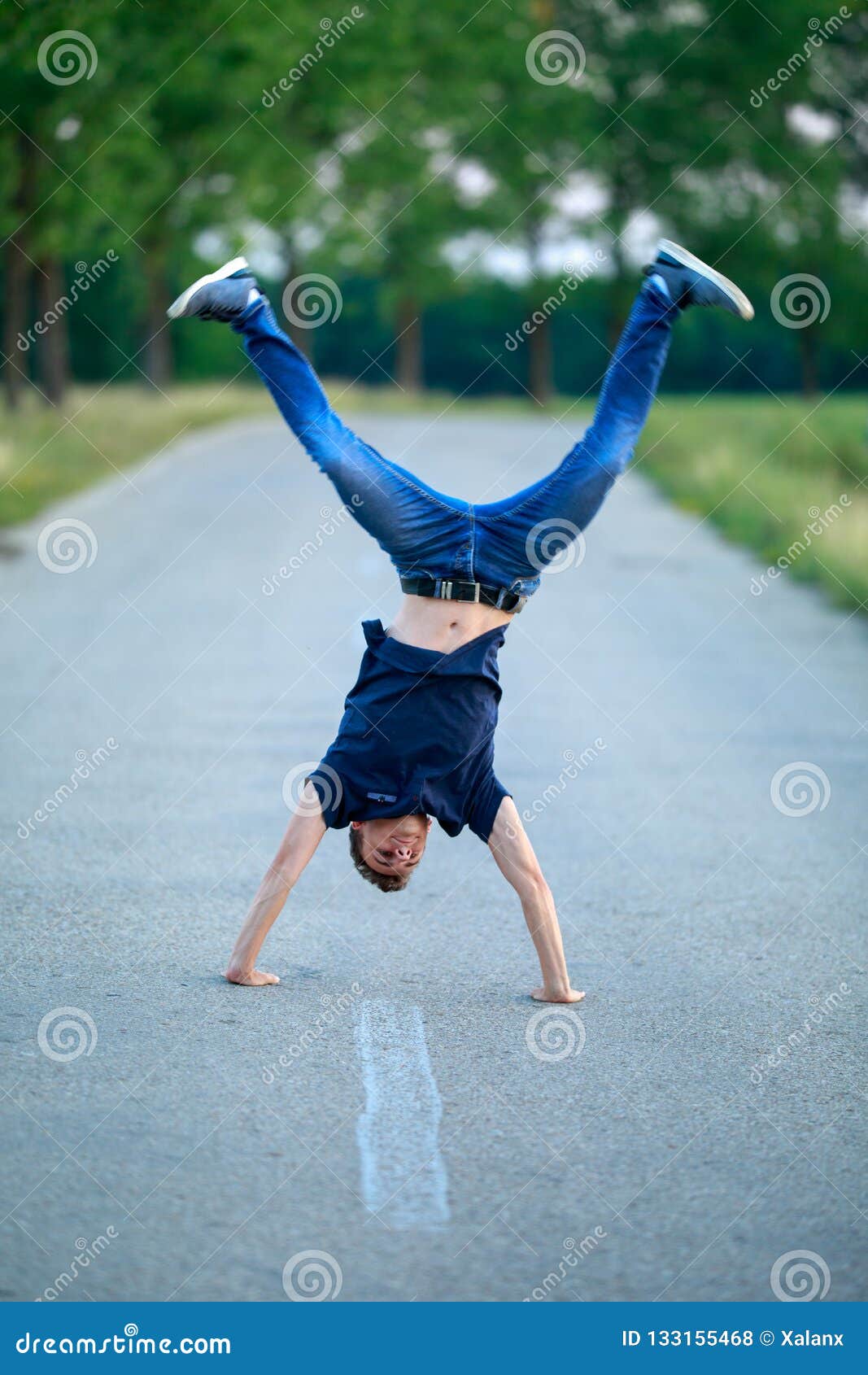 Young man walking on hands stock photo. Image of activity - 133155468