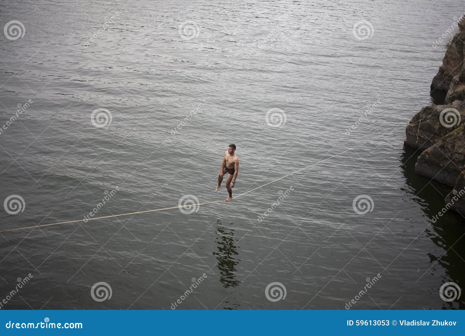 Young Man Walking on a Rope Over Water. Stock Image - Image of sports ...