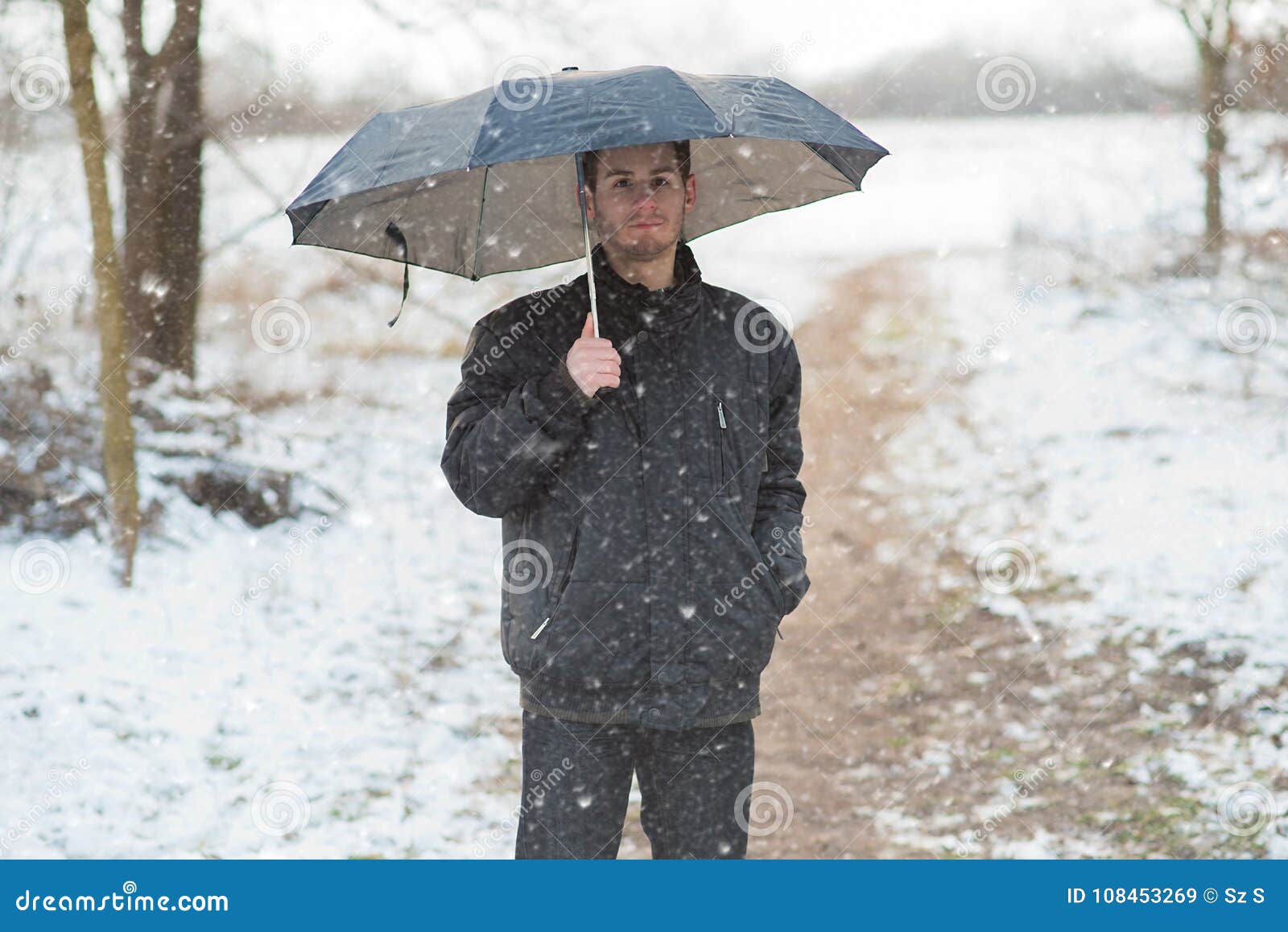 Young Man Walking in the Snowfall Stock Image - Image of snowstorm ...