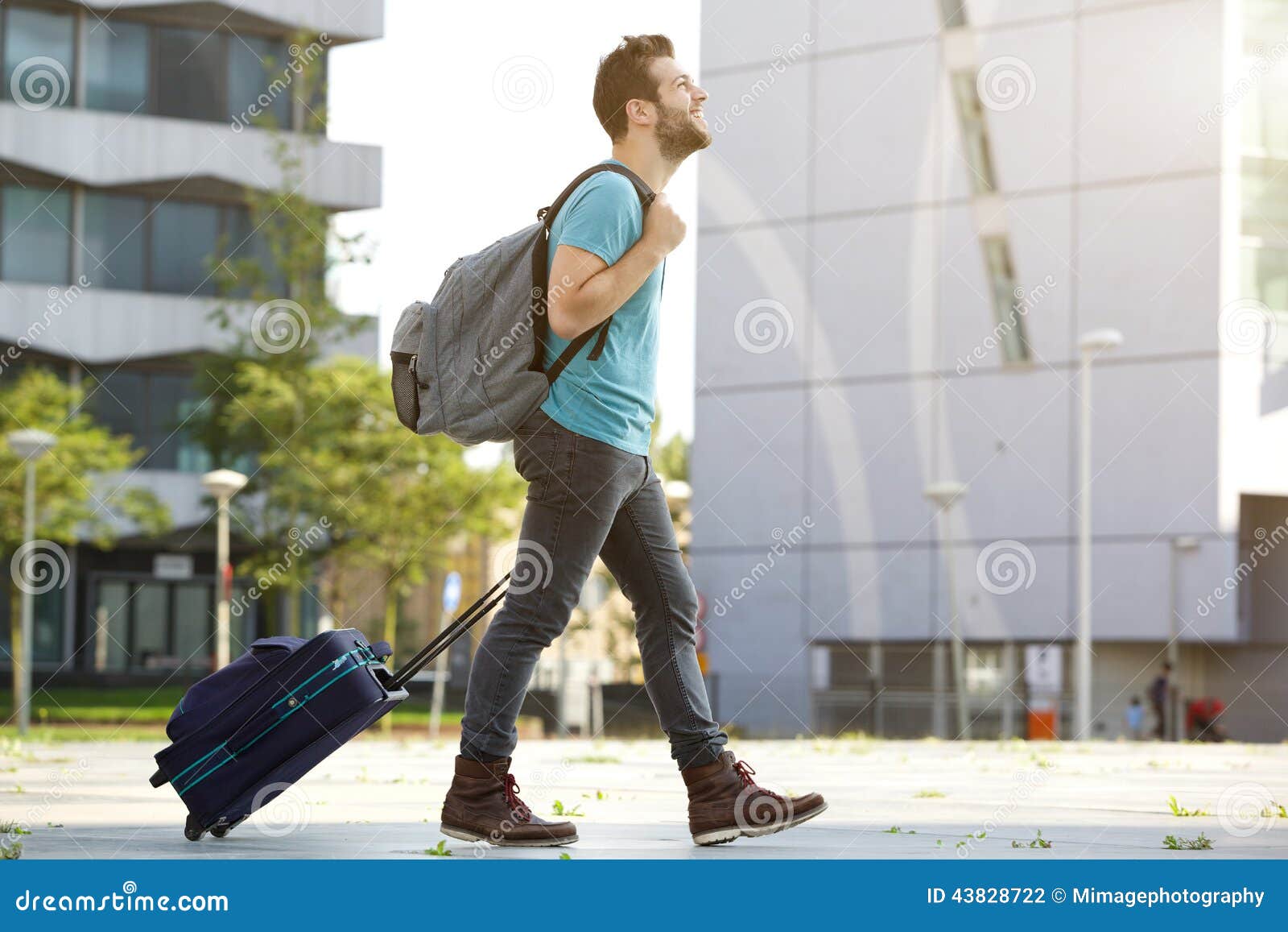 Young Man Walking with Suitcase and Bag Stock Photo - Image of ...