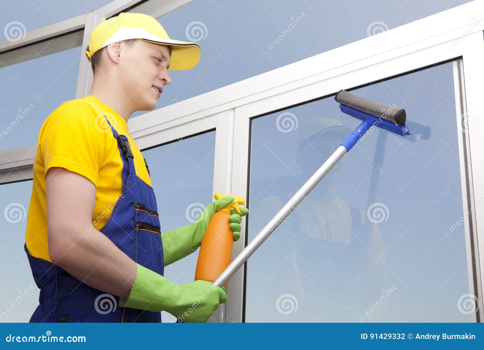 Young man washes window stock photo. Image of spray, pressurised - 91429332