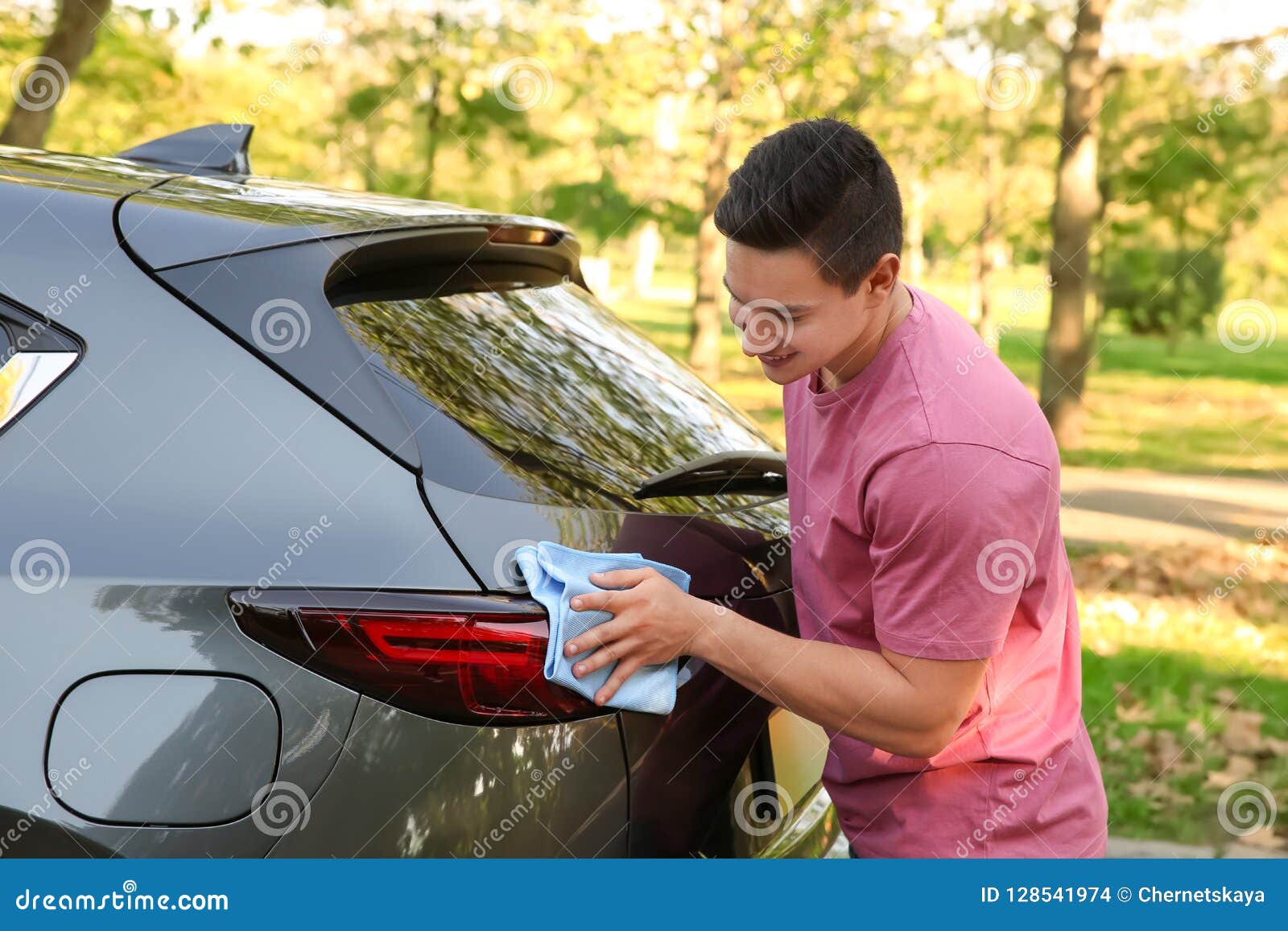Young Man Washing Car Rear Light with Rag Stock Photo - Image of glass ...
