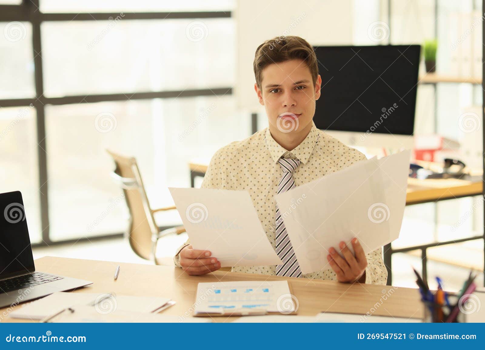 The Young Man Watches Documents in the Office, Close-up Stock Image ...