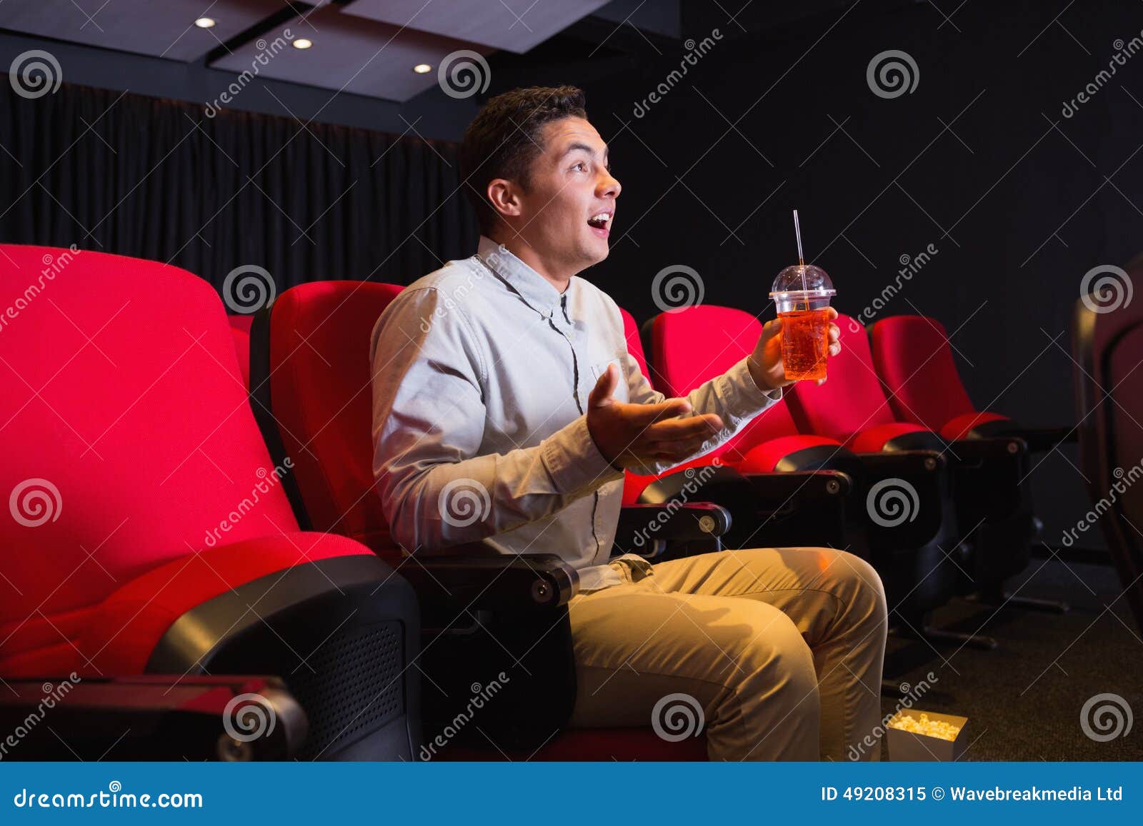 Young man watching a film stock image. Image of cinema - 49208315