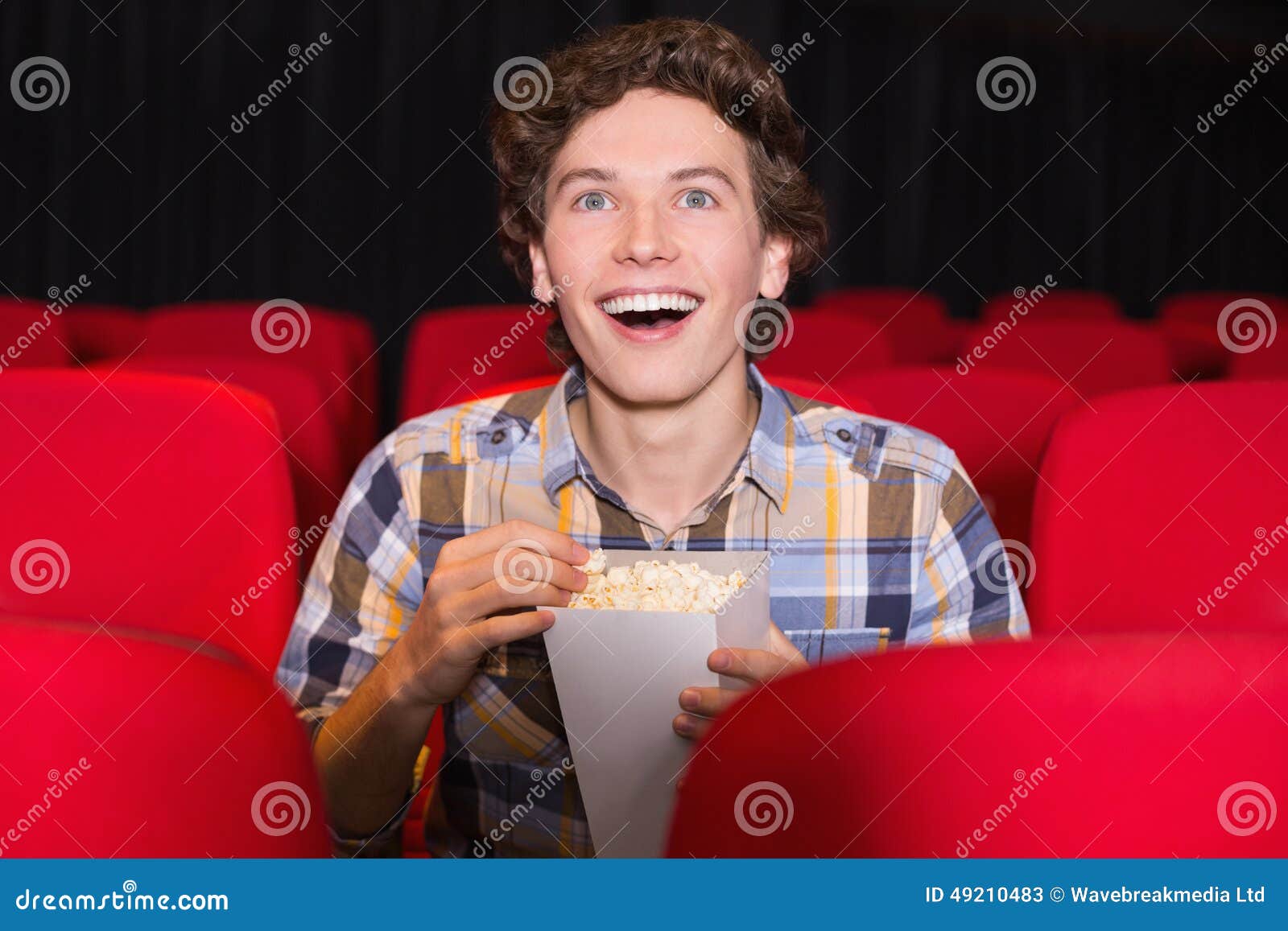 Young man watching a film stock image. Image of entertainment - 49210483