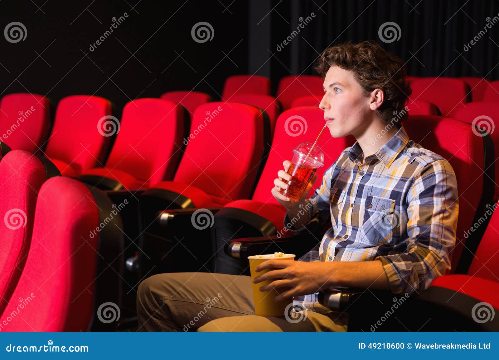 Young man watching a film stock photo. Image of leisure - 49210600