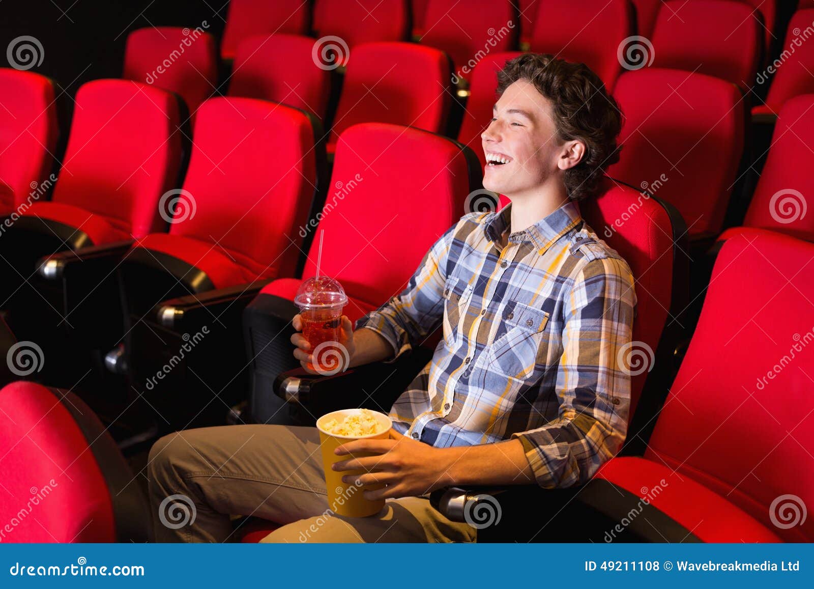 Young man watching a film stock photo. Image of glasses - 49211108