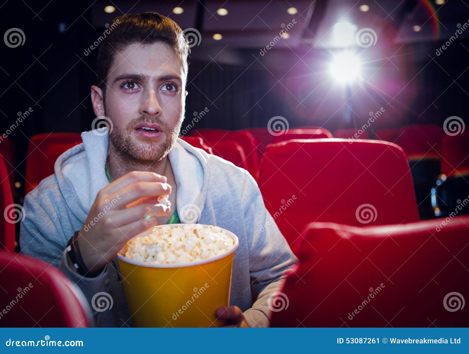 Young man watching a film stock image. Image of aback - 53087261