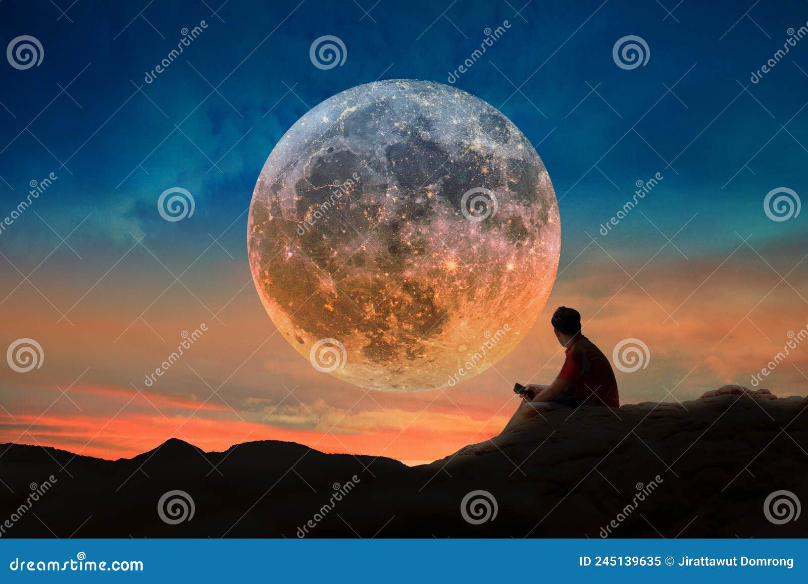 Young Man is Watching the Full Moon on a Beautiful Sunset Stock Image ...