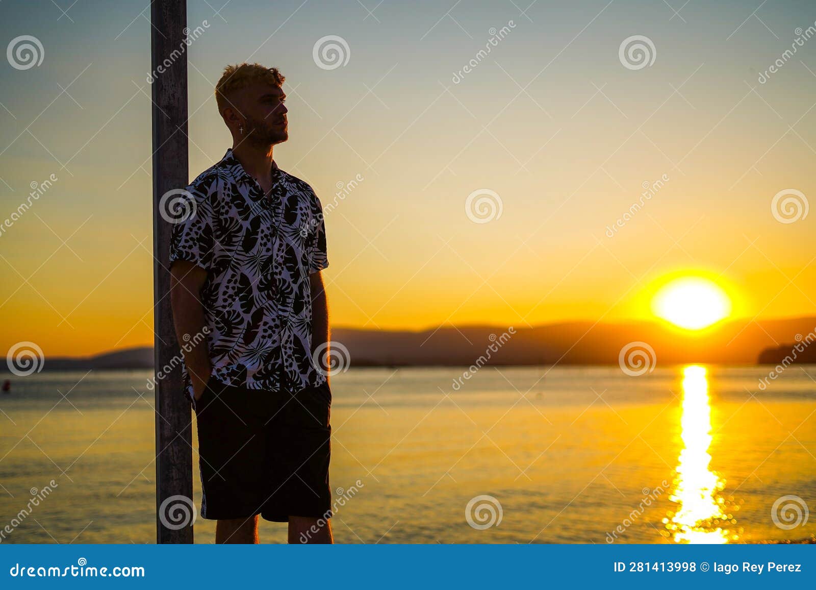 Young Man Watching the Sunset Stock Photo - Image of female, blue ...