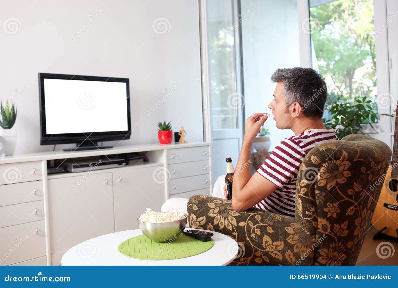 Young man watching TV stock photo. Image of enjoying - 66519904