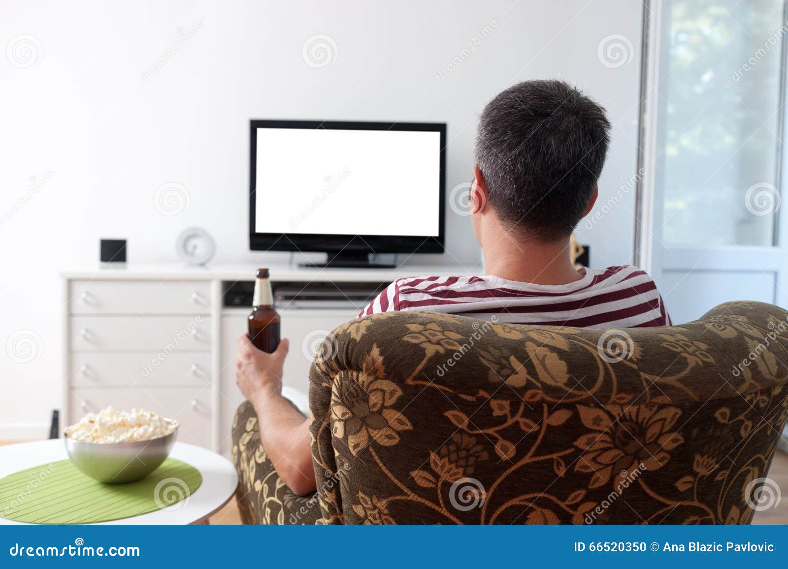 Young man watching TV stock photo. Image of popcorn, beer - 66520350