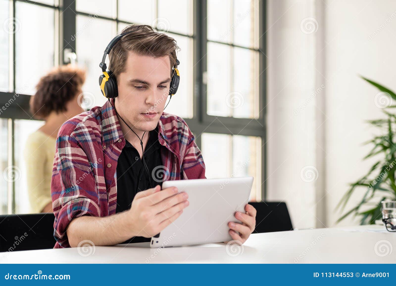 Young Man Watching a Video on Tablet PC at Work Stock Image - Image of ...