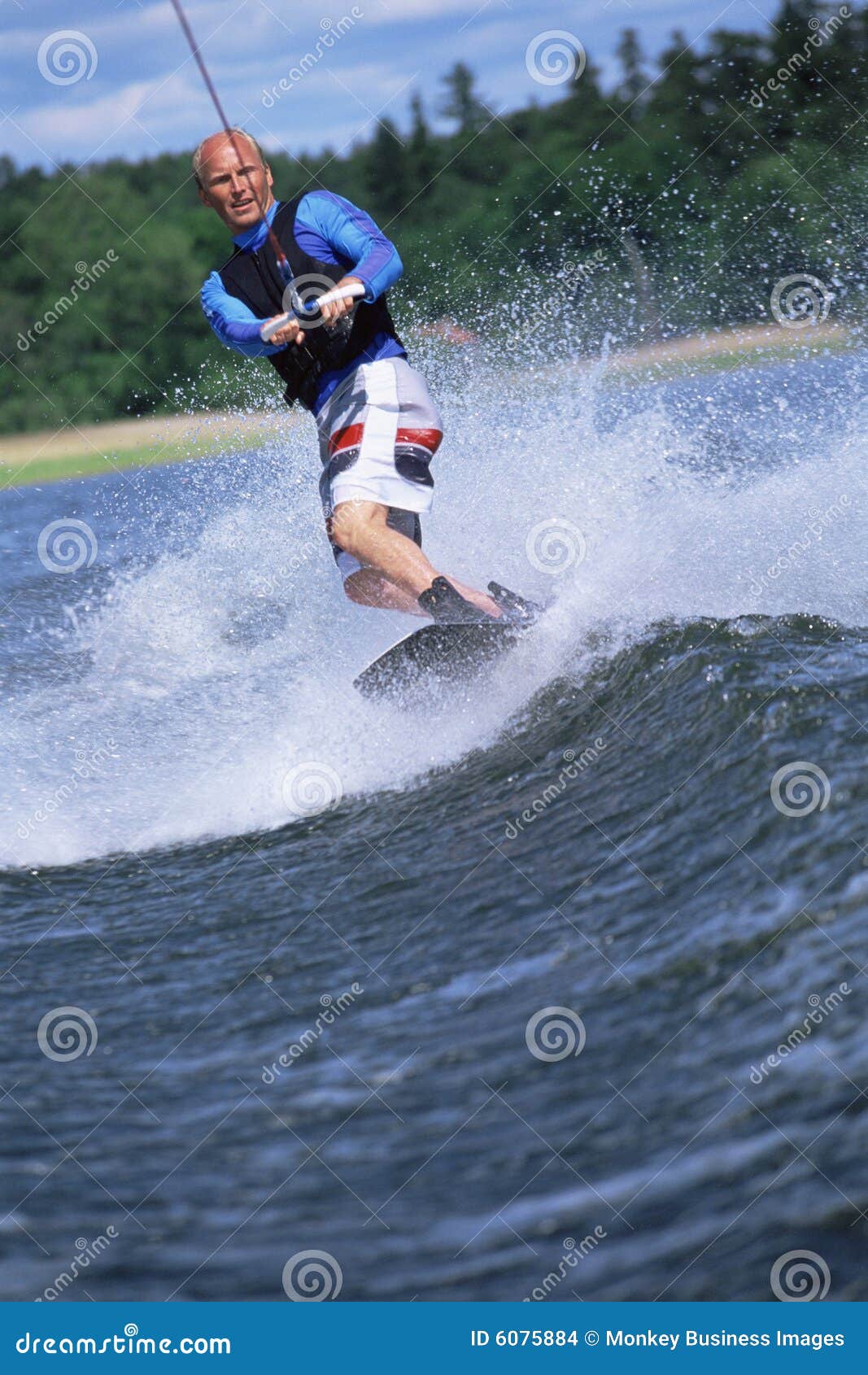 A young man water skiing stock photo. Image of water, vertical - 6075884