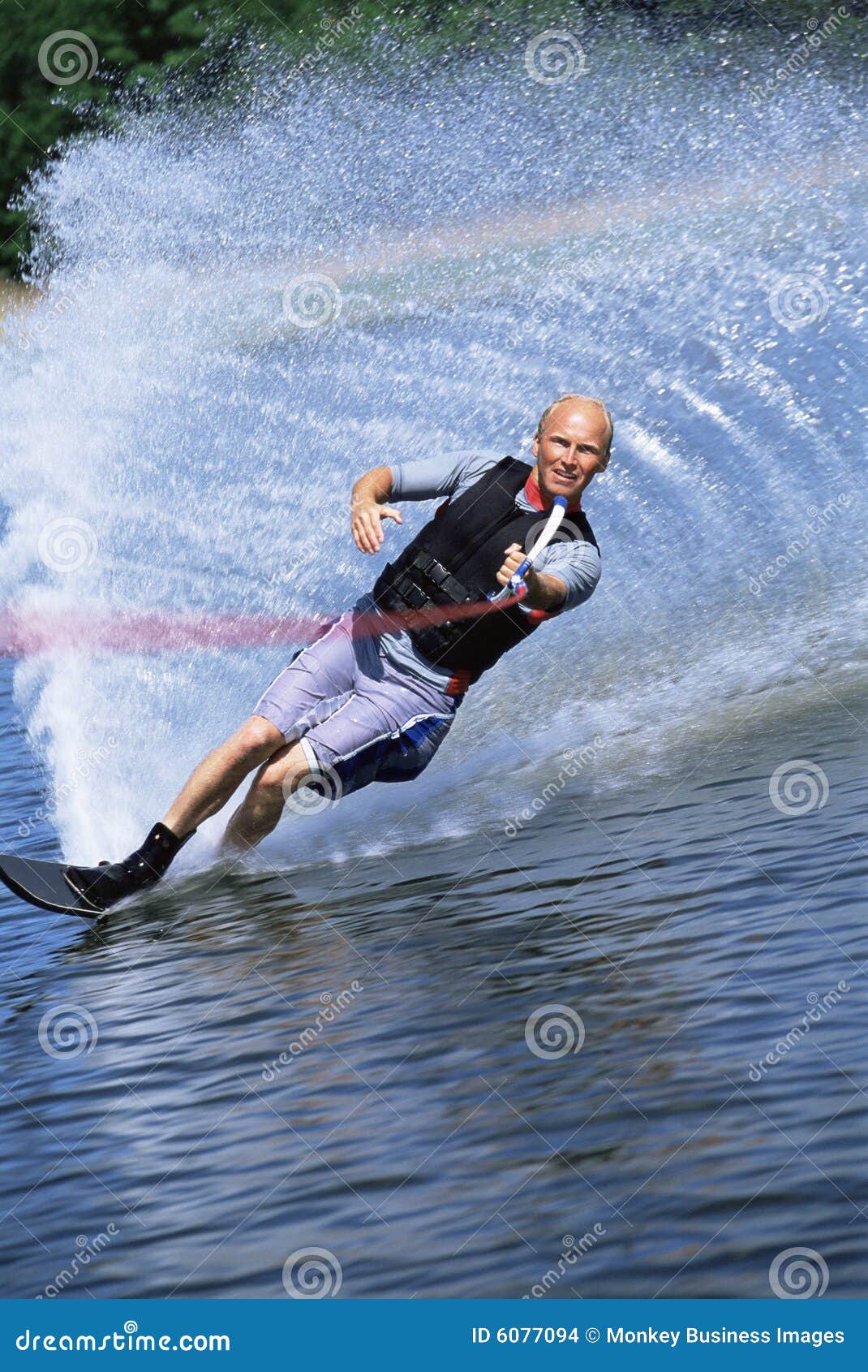 A young man water skiing stock photo. Image of thrilling - 6077094
