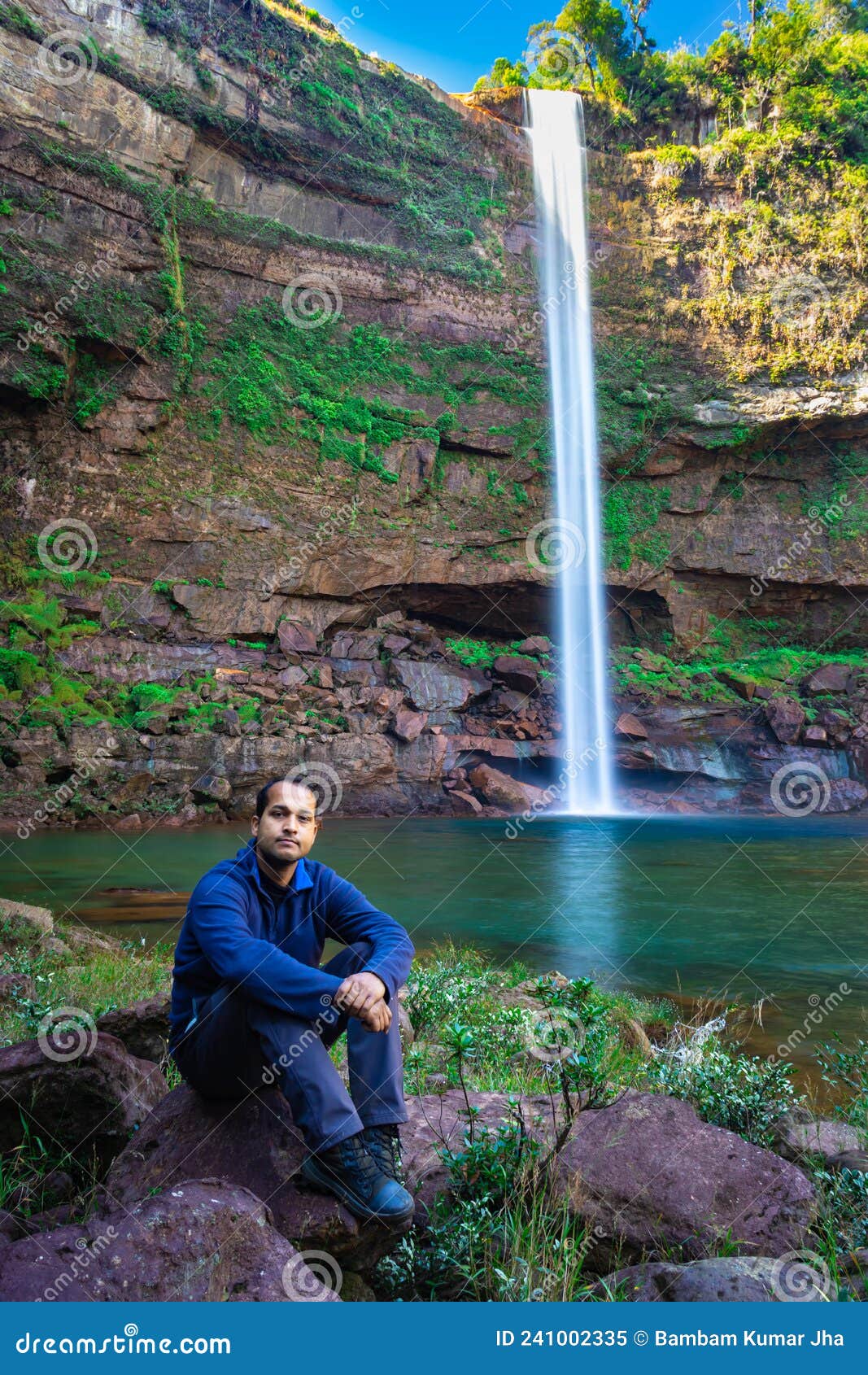 Young Man at Waterfall Falling Streams from Mountain Top with ...