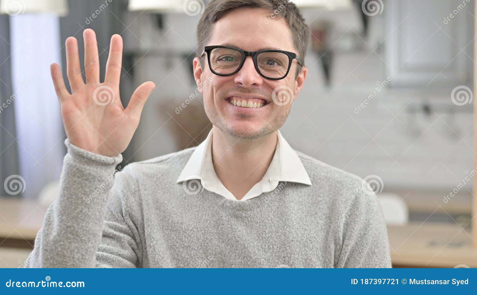 Young Man Waving at the Camera Stock Image - Image of greeting, males ...