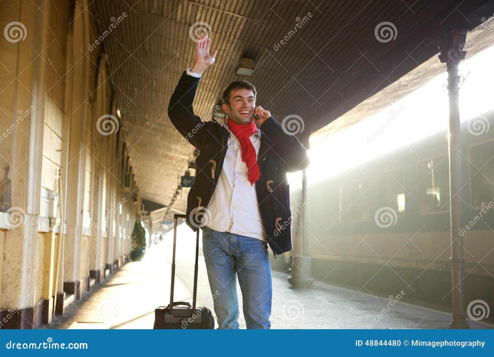 Young Man Waving Hand at Train Station Stock Photo - Image of station ...