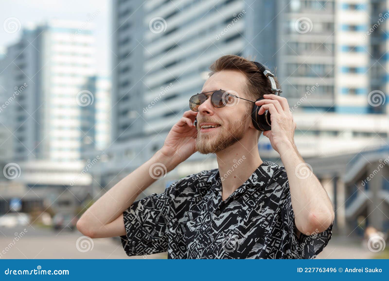 A Young Man Wearing Headphones And Sunglasses Listens To Music Stock