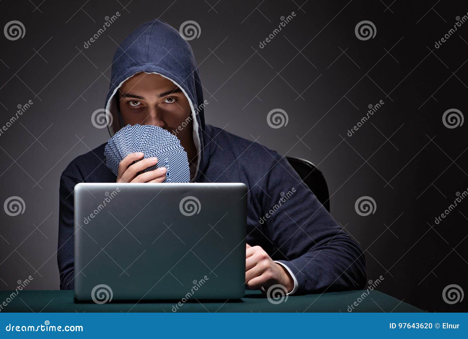 Young Man Wearing a Hoodie Sitting in Front of a Laptop Computer Stock ...