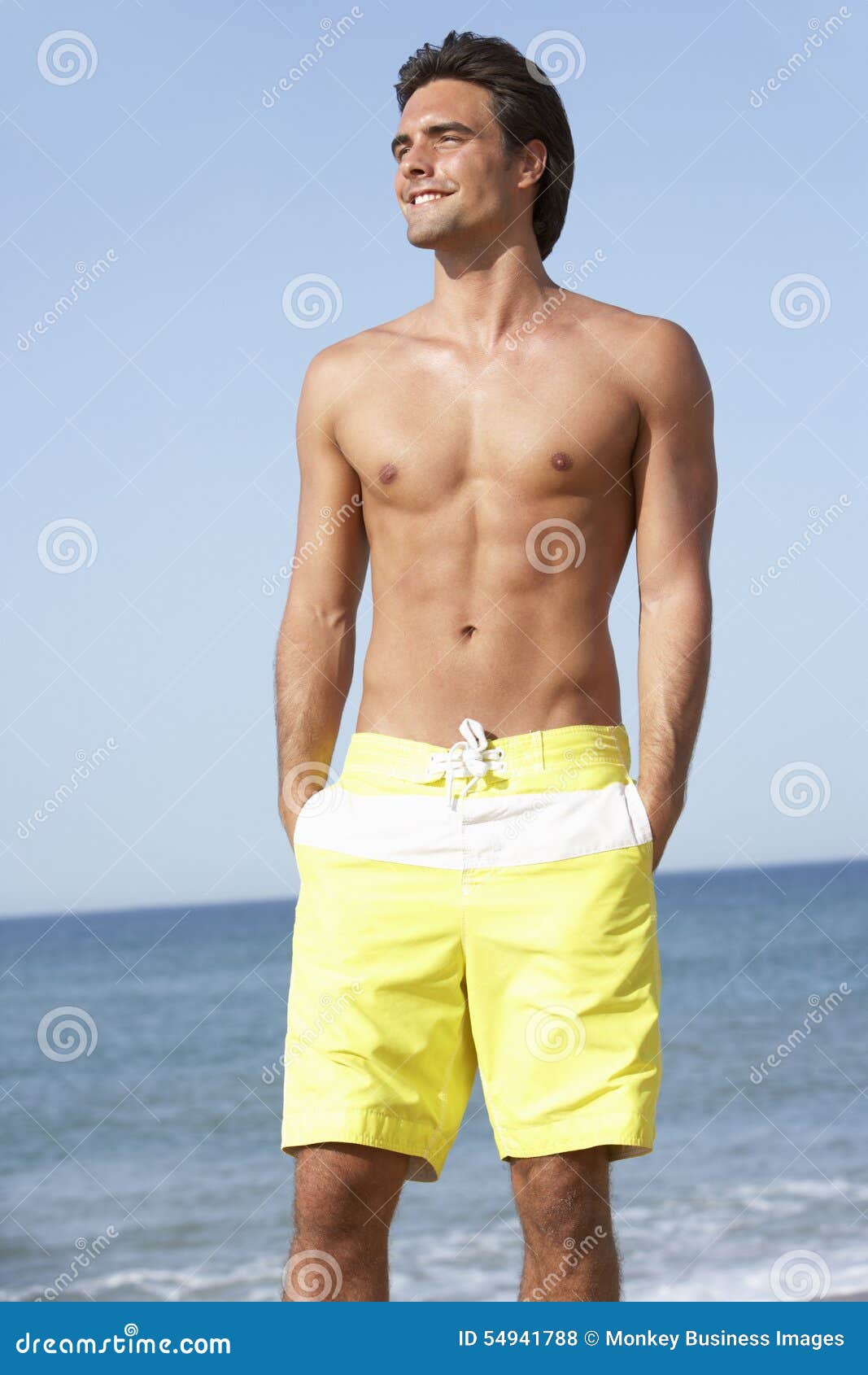 Young Man Wearing Swimming Costume Standing on Beach Stock Photo ...