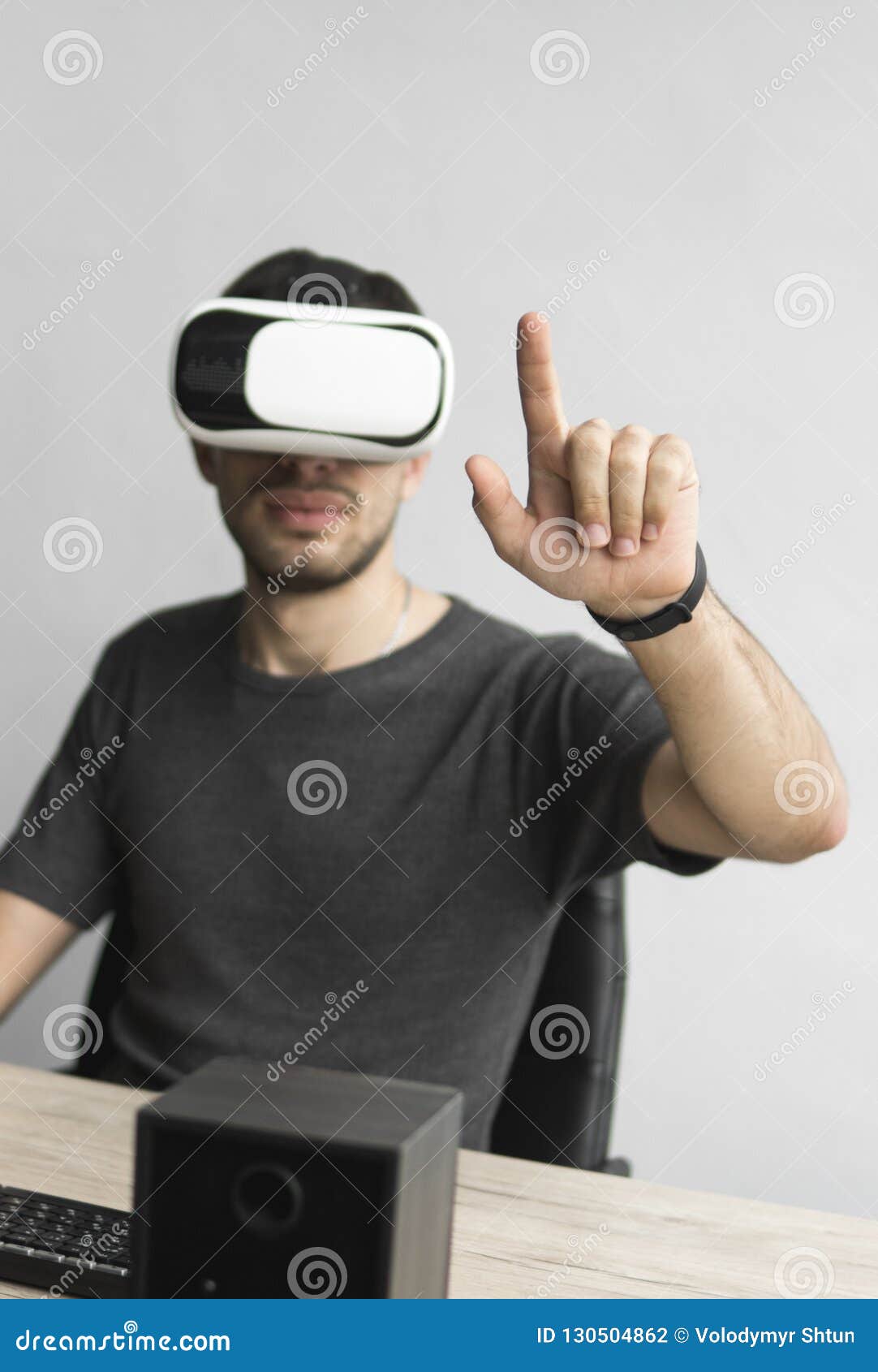 Young Man Wearing Virtual Reality Goggles Headset and Sitting in the ...