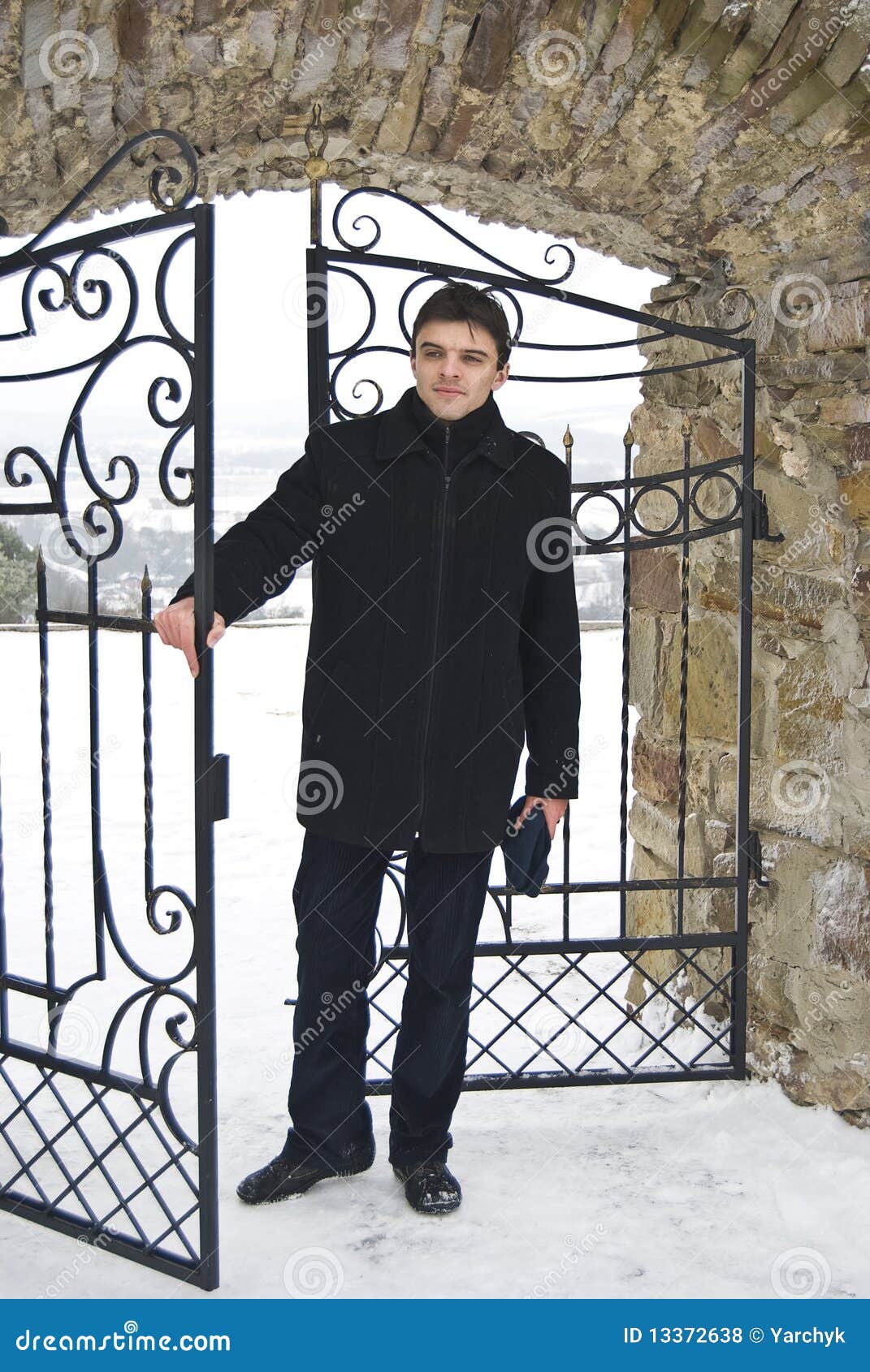 Young man at a welded gate stock photo. Image of entrance - 13372638