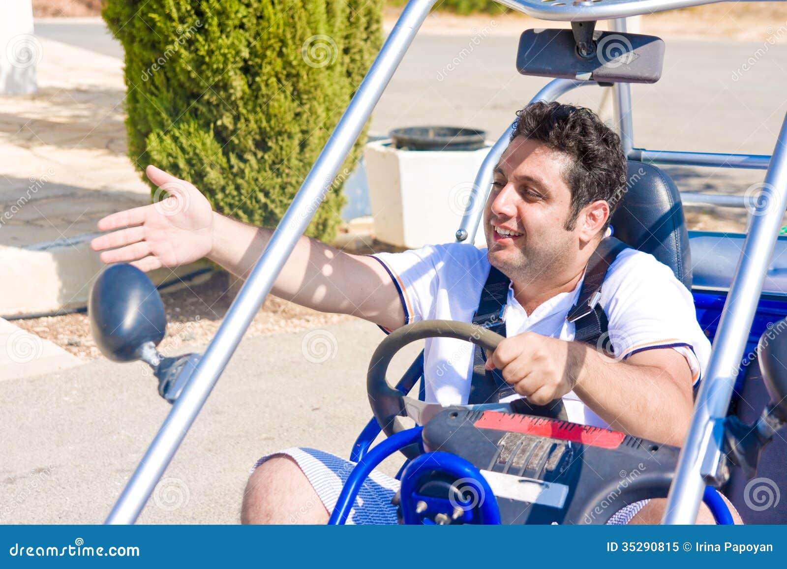 Young Man at Wheel of Buggy Shows Hand Aside Stock Image - Image of ...