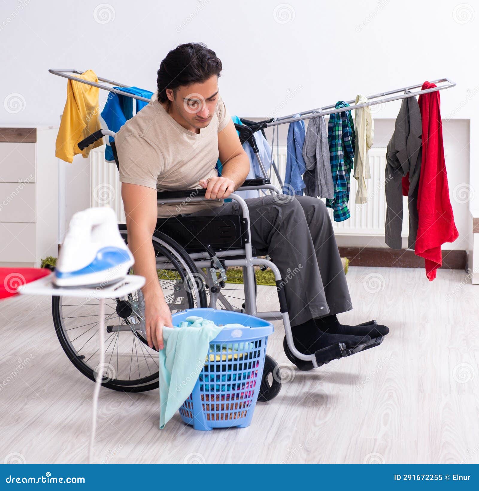 Young Man in Wheel-chair Doing Ironing at Home Stock Image - Image of ...