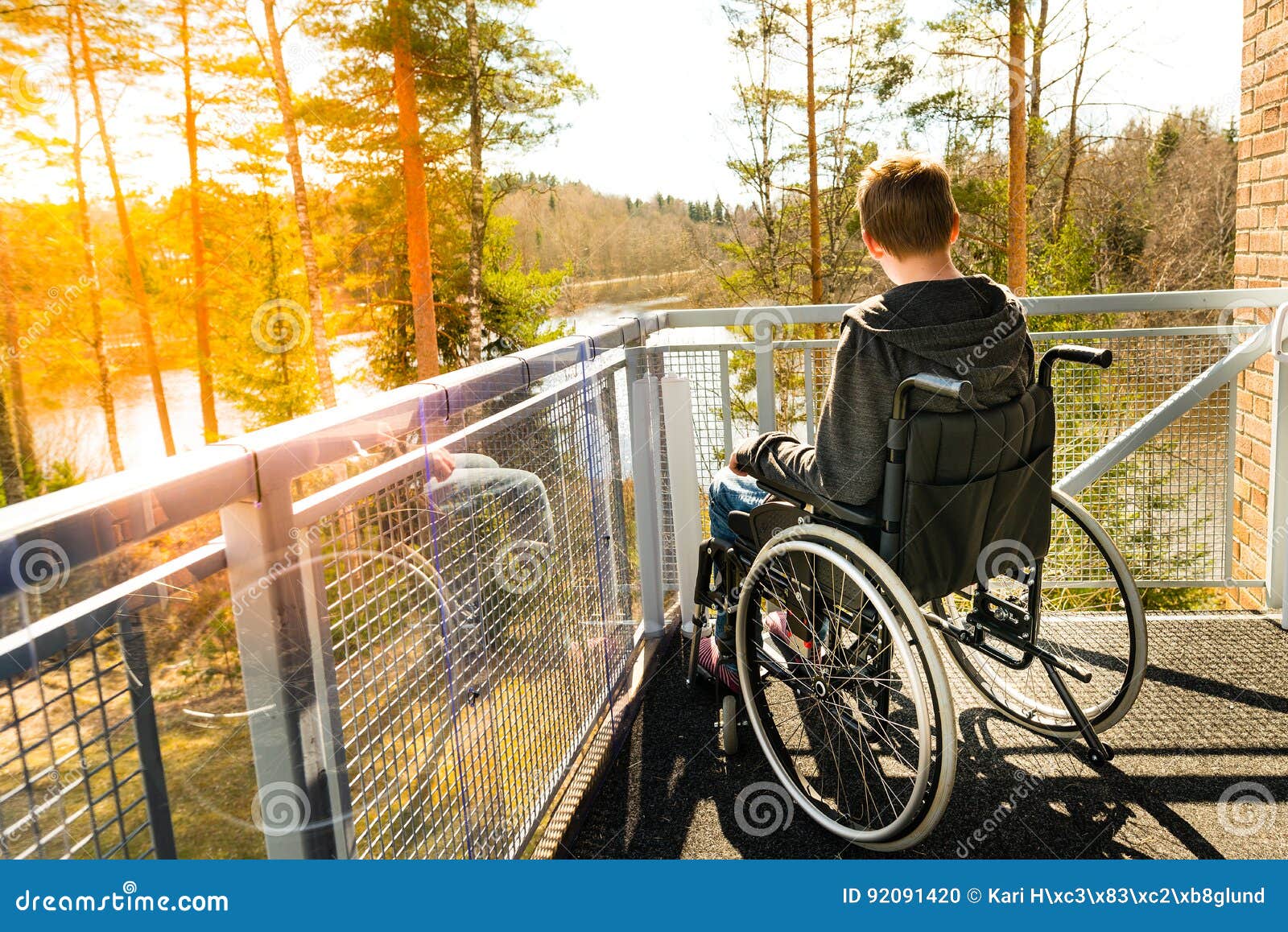 Young Man in a Wheelchair on a Balcony Looking at the Nature in Stock ...