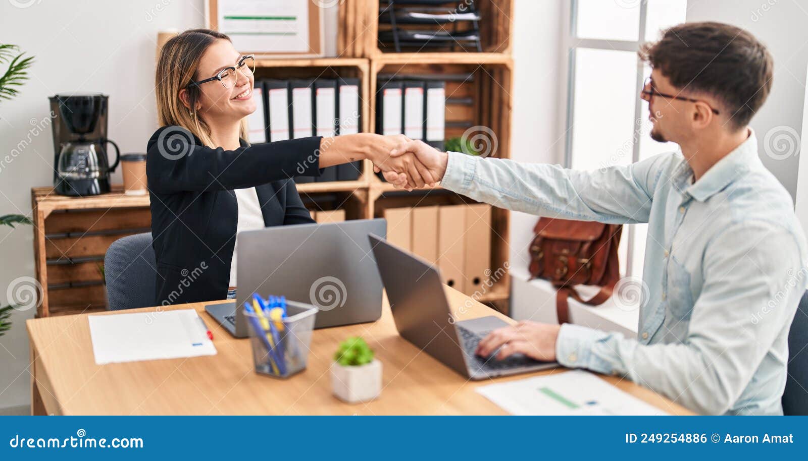 Young Man and Woman Business Workers Shake Hands Working at Office ...