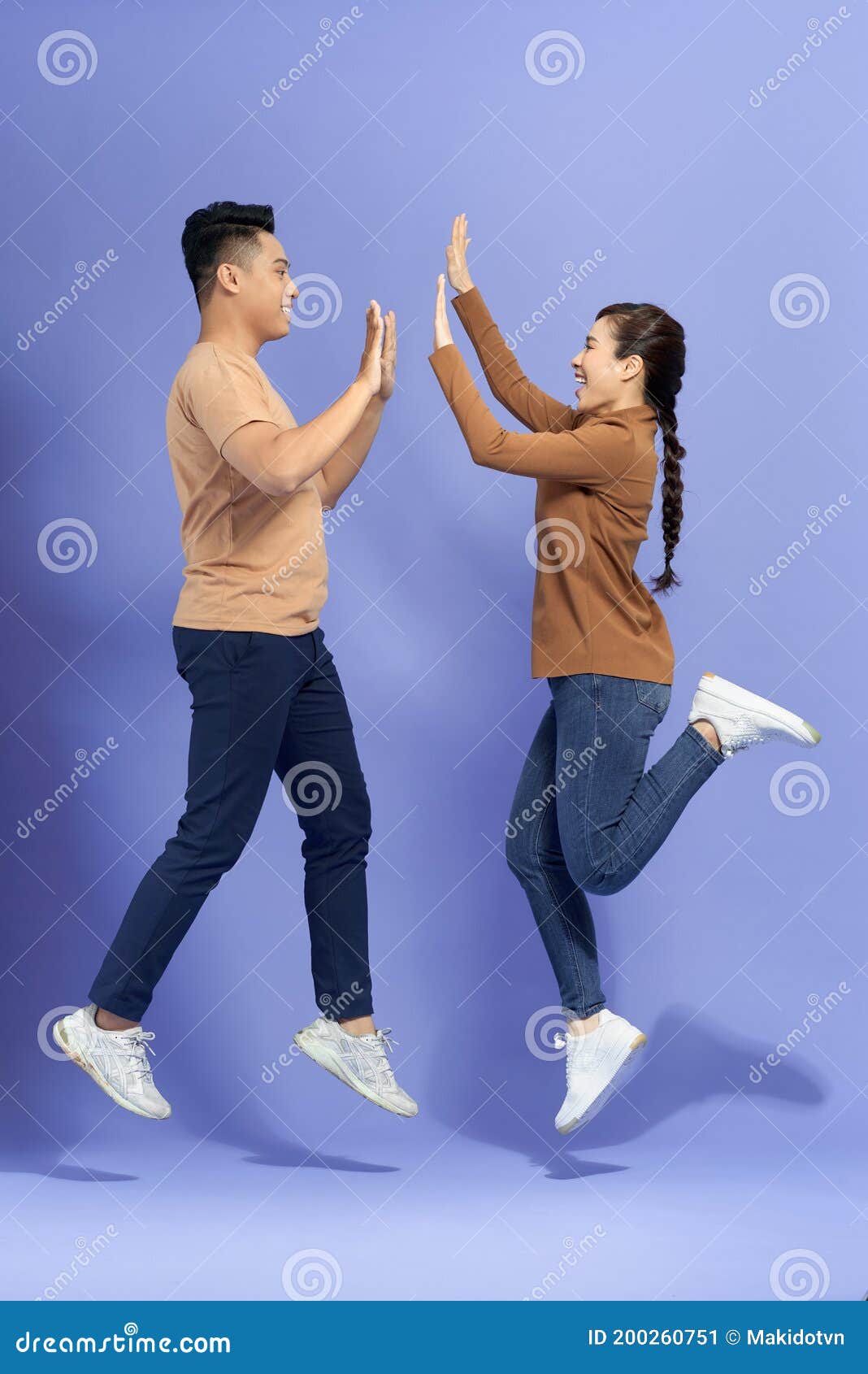 Young Man with Woman Jumping and Giving High Five Stock Image - Image ...