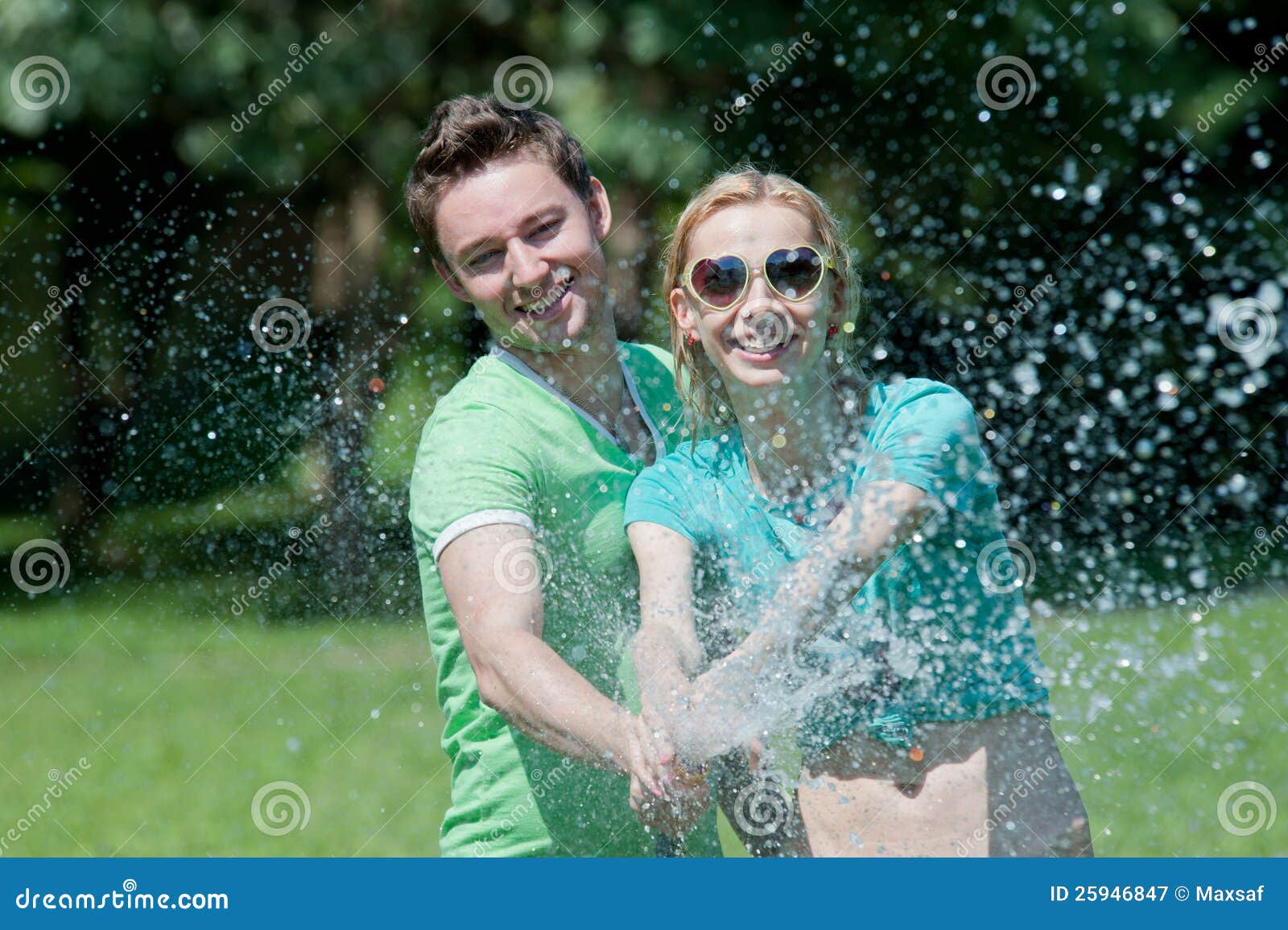 Young Man and Woman Playing with Water Spray Stock Image - Image of ...