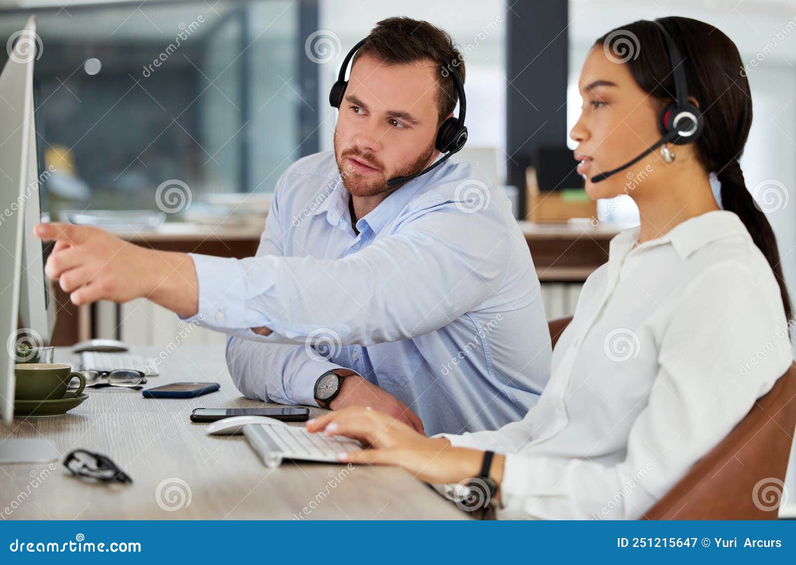 Teamwork Makes the Call Work. a Young Man and Woman Using a Computer ...