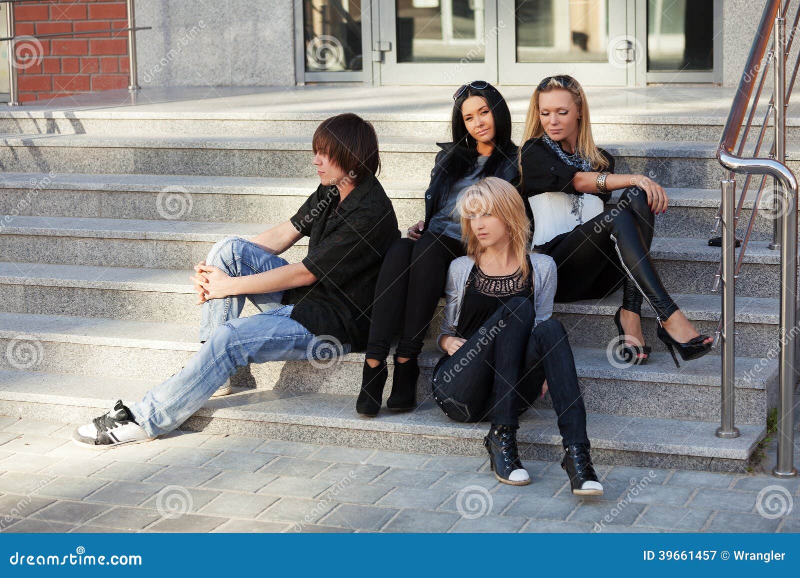 Group of Young Fashion People Sitting on the Steps Stock Image - Image ...