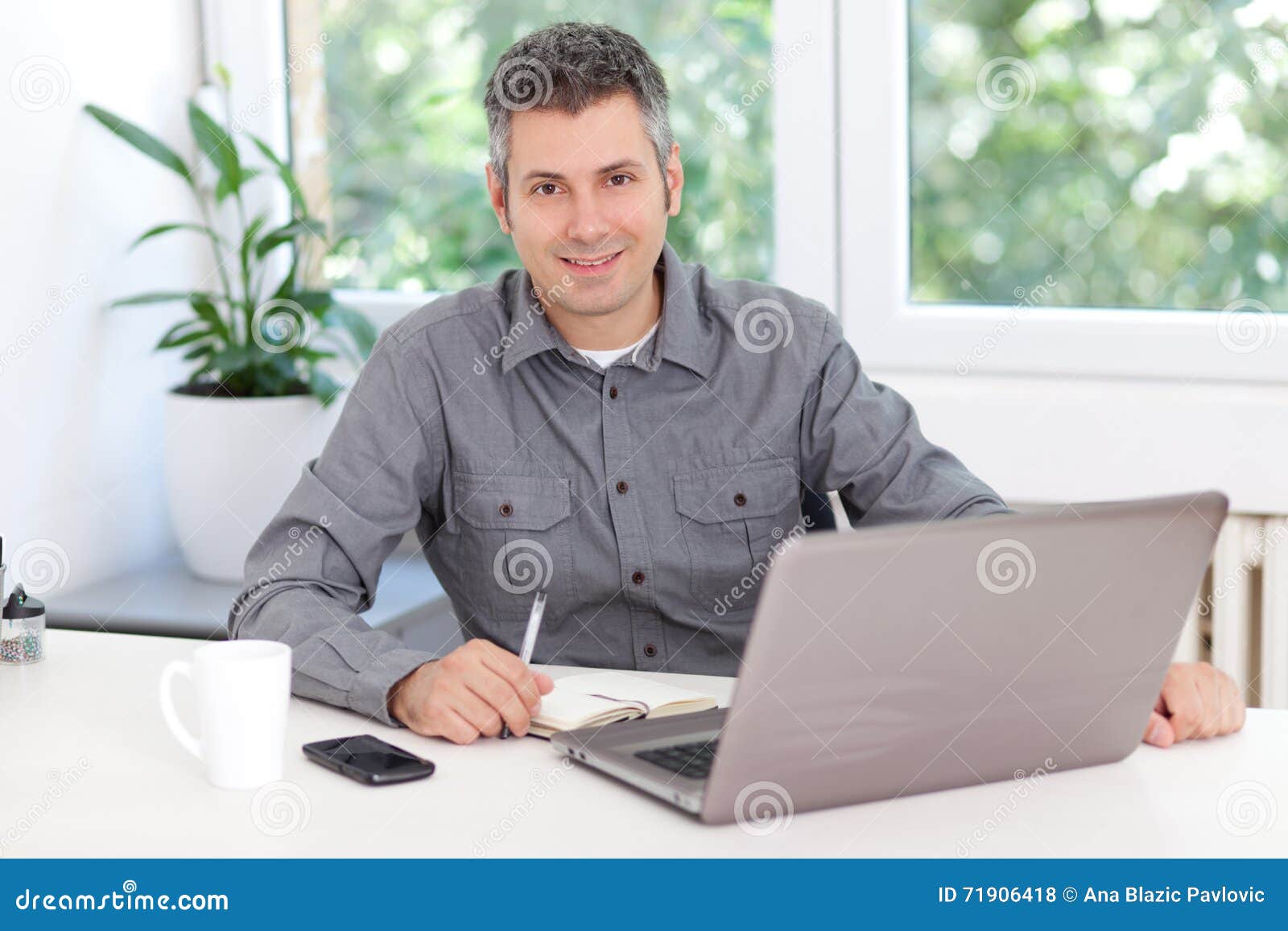 Young man at work stock photo. Image of cheerful, desk - 71906418