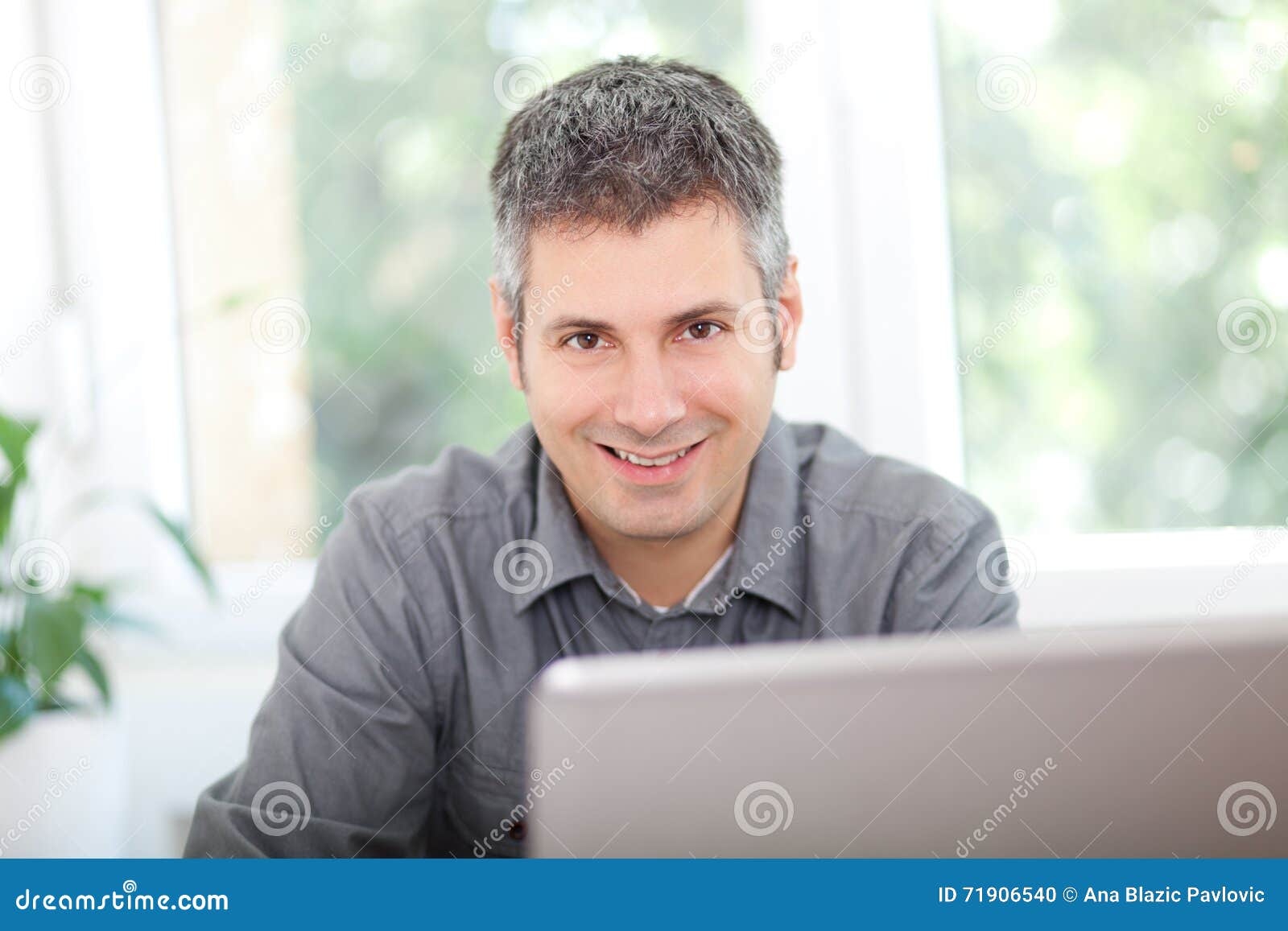Young man at work stock photo. Image of good, grey, computer - 71906540
