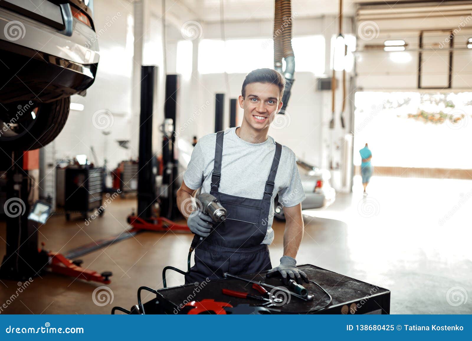 A Young Man is at Work while Preparing for Changing a Tire Stock Image ...