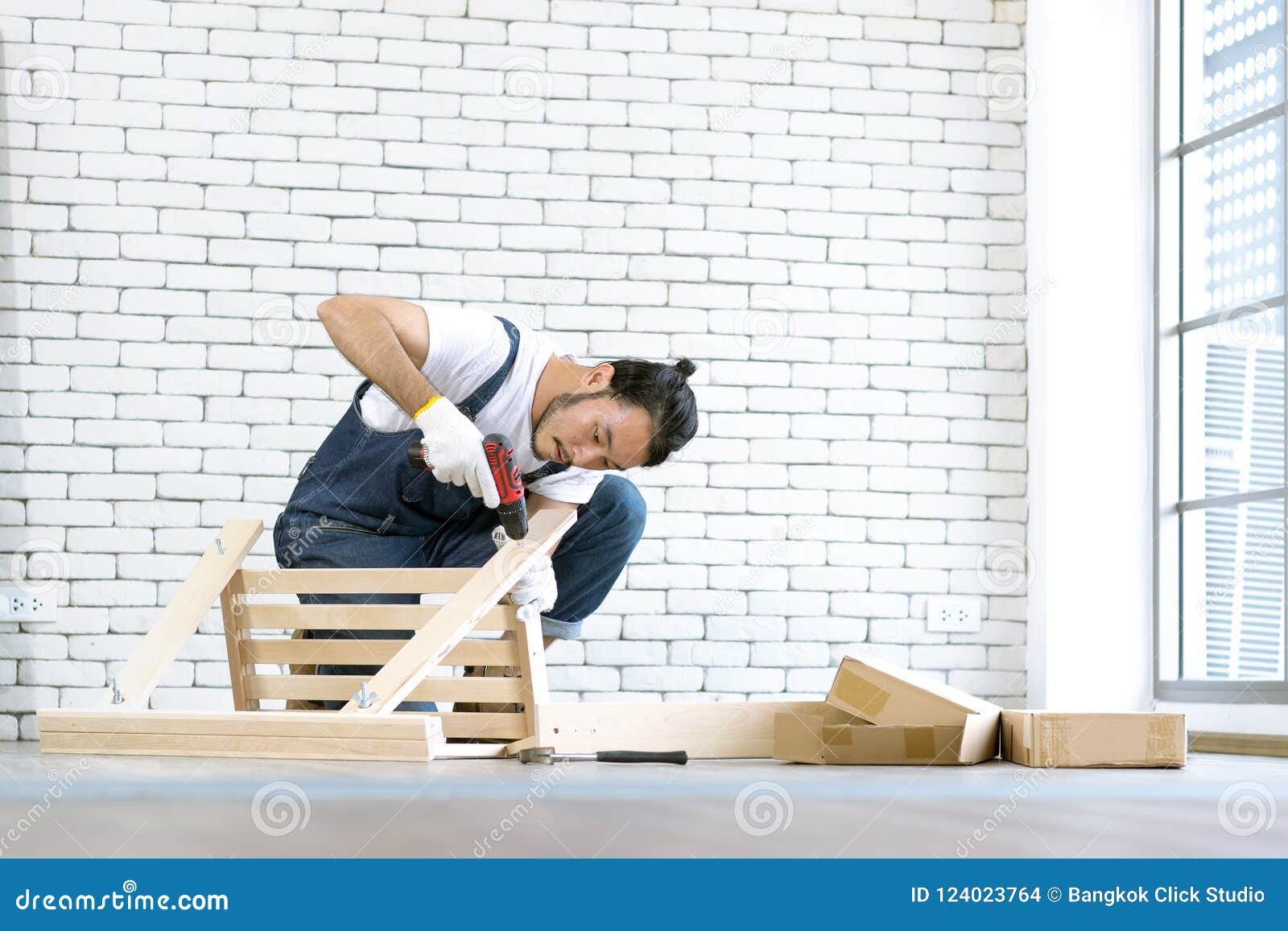 Young Man Working As Handyman, Assembling Wood Table with Equipments ...